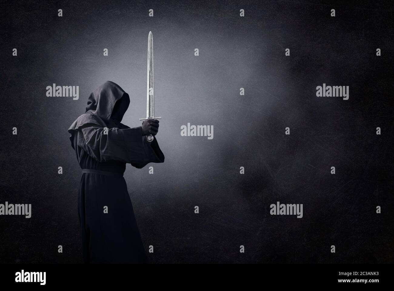 Ghostly figure with medieval sword in the dark Stock Photo - Alamy