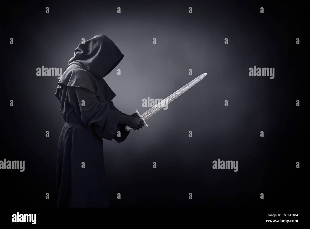 Ghostly figure with medieval sword in the dark Stock Photo - Alamy