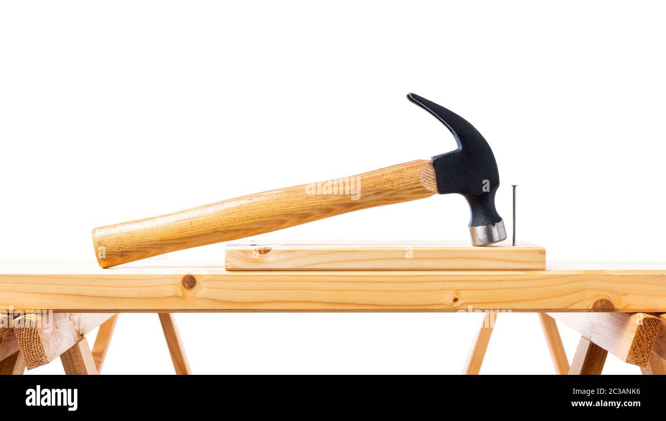 Close-up. Carpenter’s hammer over a wooden board. Construction industry ...