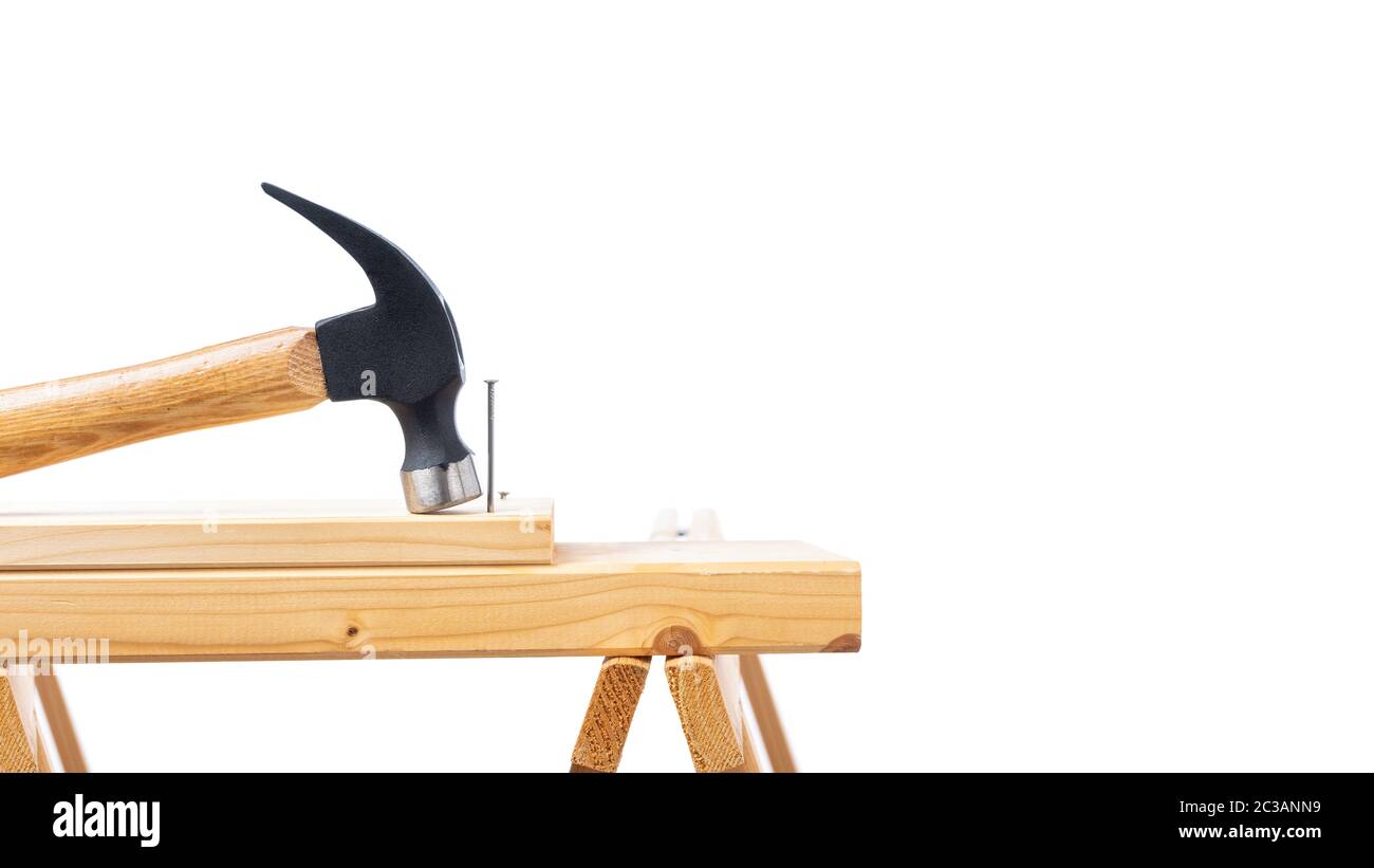 Close-up. Carpenter’s hammer over a wooden board. Construction industry ...