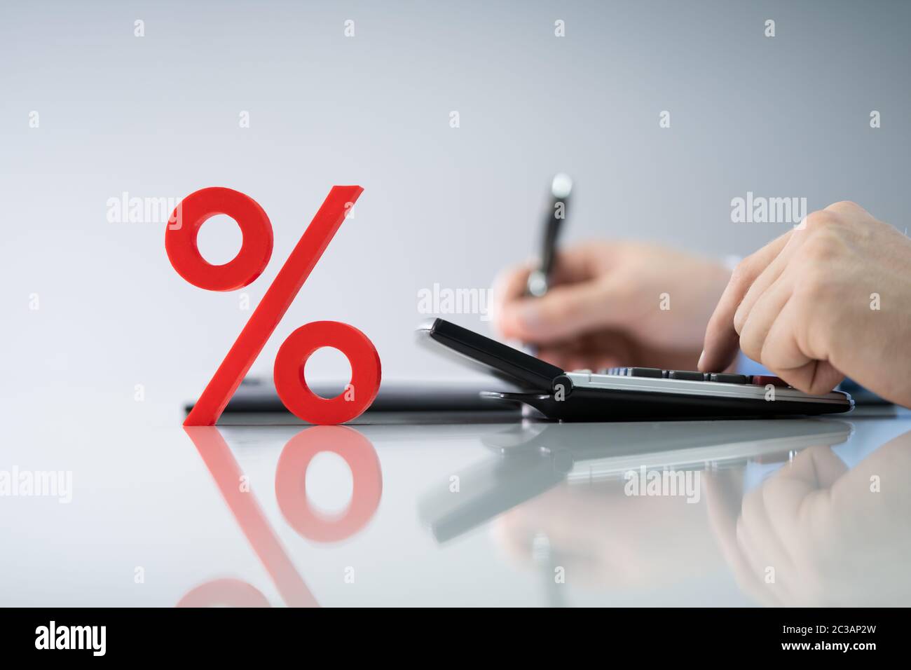 Close-up Of Red Percentage Symbol In Front Of Businessperson ...