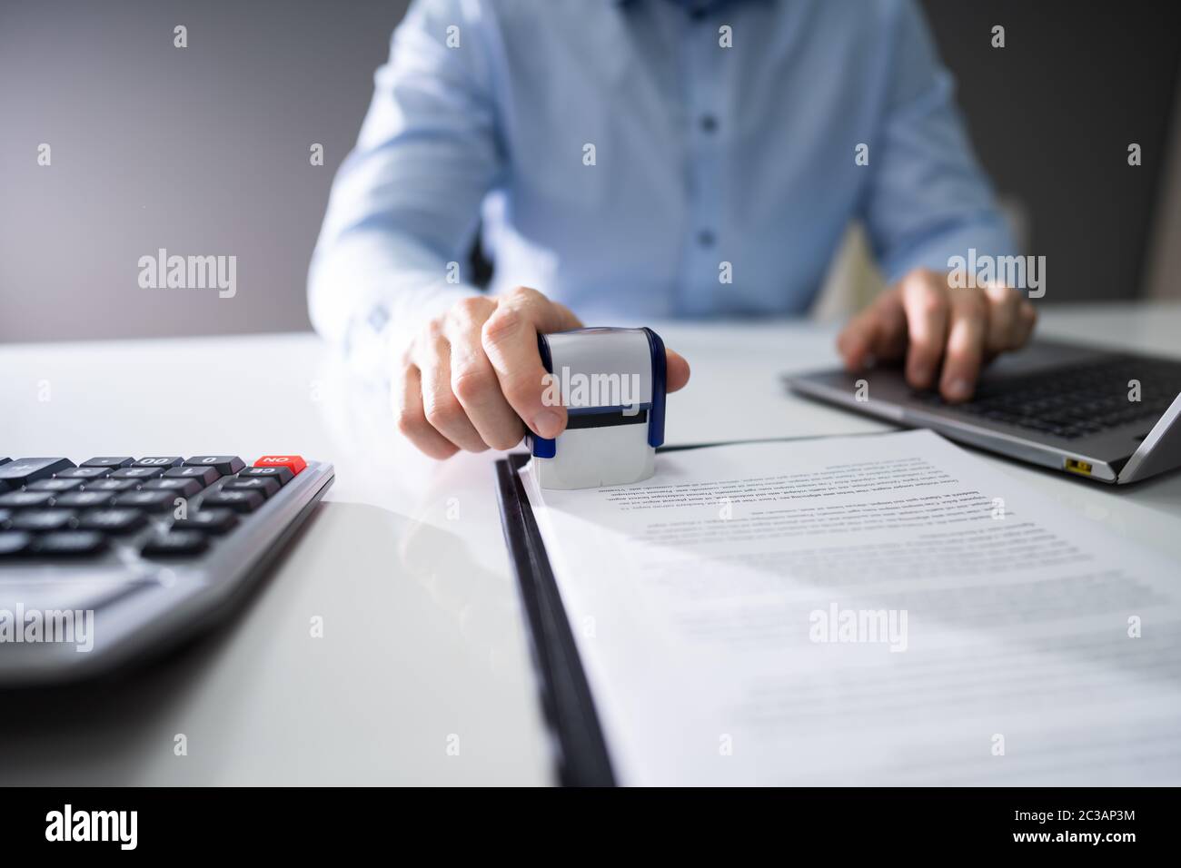 Close-up Of A Person's Hand Stamping On Approved Application Form Over ...