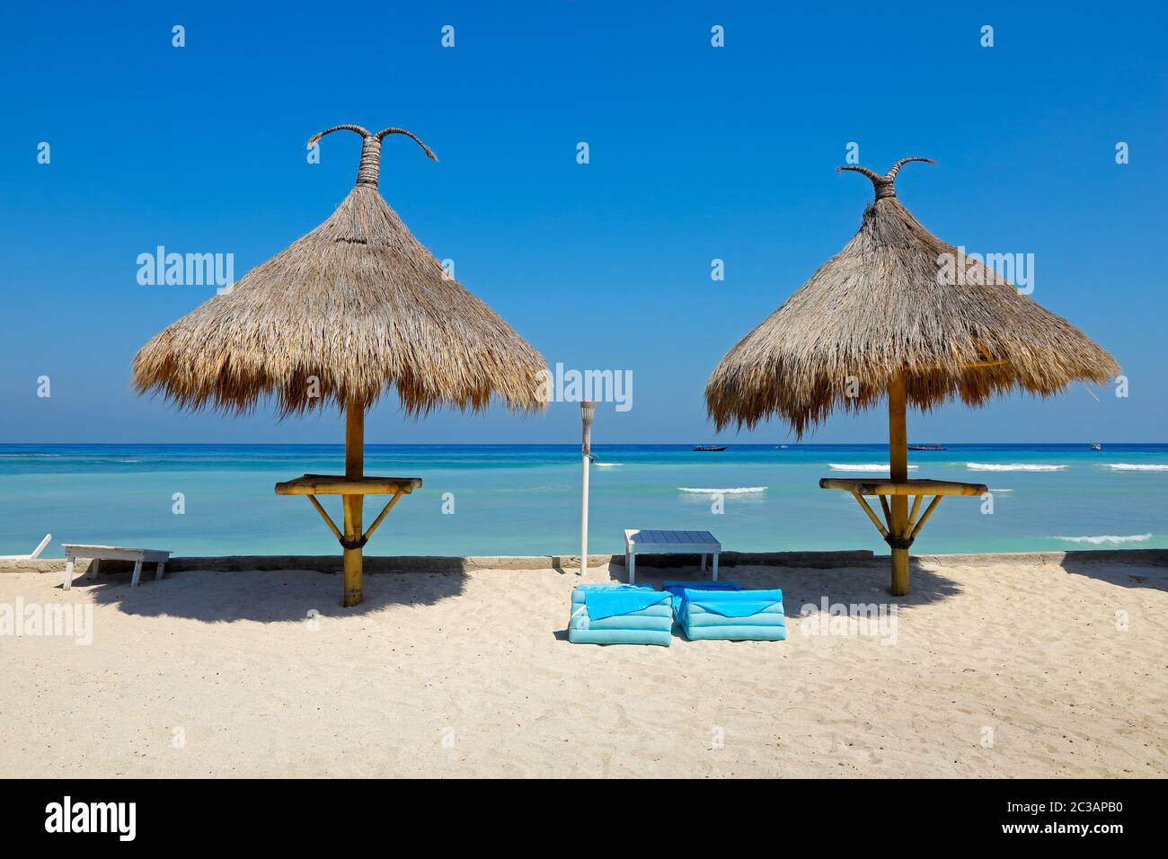 Thatched shades on a scenic tropical island beach, Bali, Indonesia ...