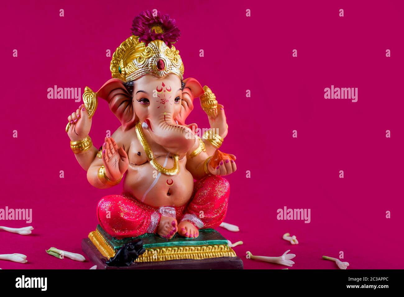 Hindu God Ganesha. Ganesha Idol on pink background Stock Photo - Alamy