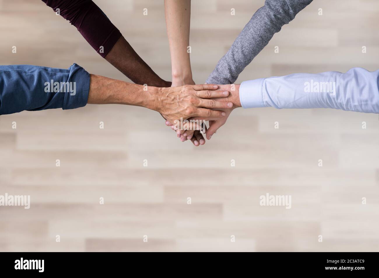 Many hands stacked hi-res stock photography and images - Alamy