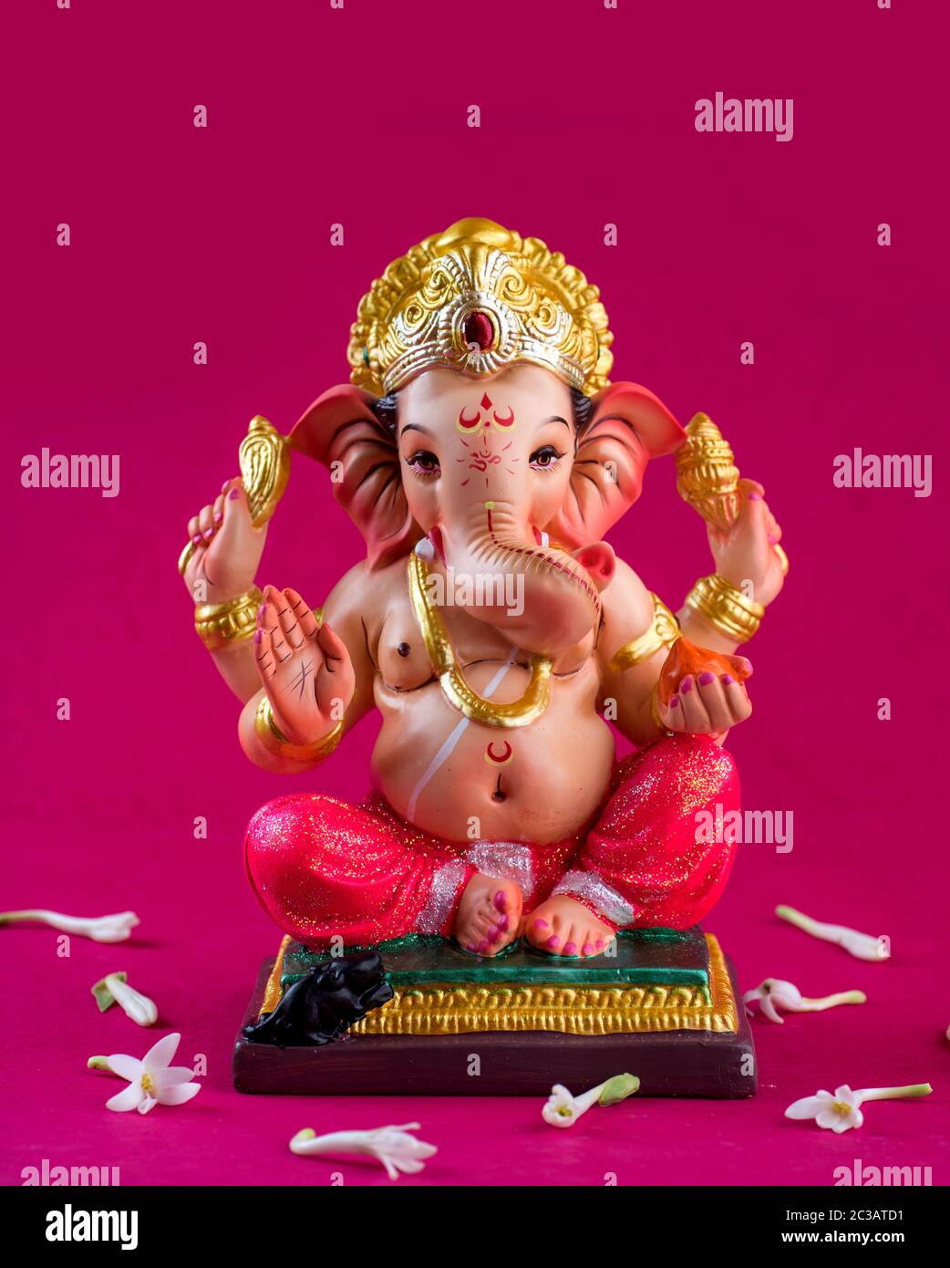 Hindu God Ganesha. Ganesha Idol on pink background Stock Photo - Alamy