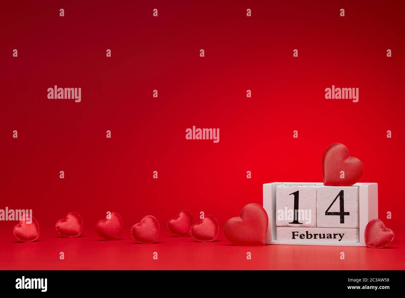 Group of silk red hearts, calendar with date 14 february on red ...
