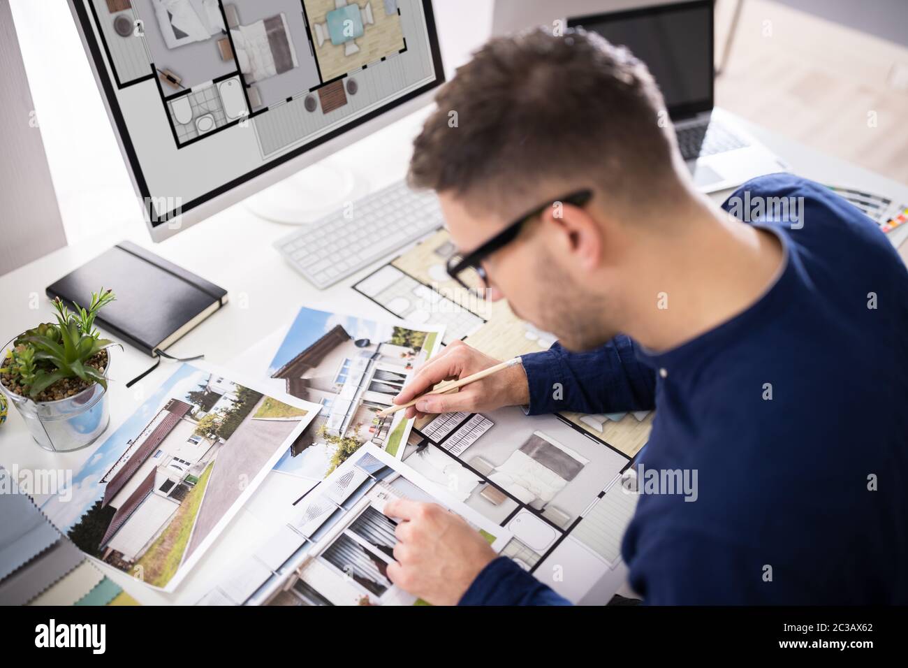 Side View Of Real Estate Designer Working On Computer In Office Stock ...