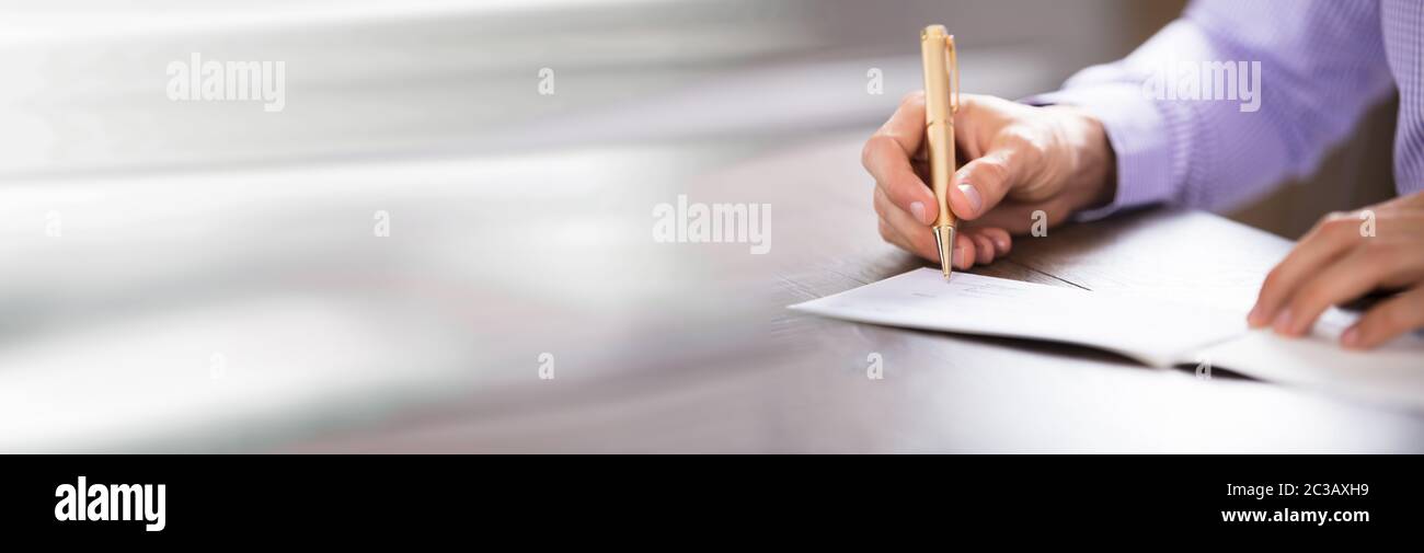 Signing a cheque hi-res stock photography and images - Alamy