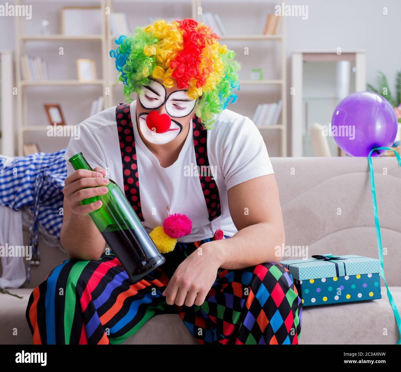 Drunk clown celebrating having a party at home Stock Photo - Alamy