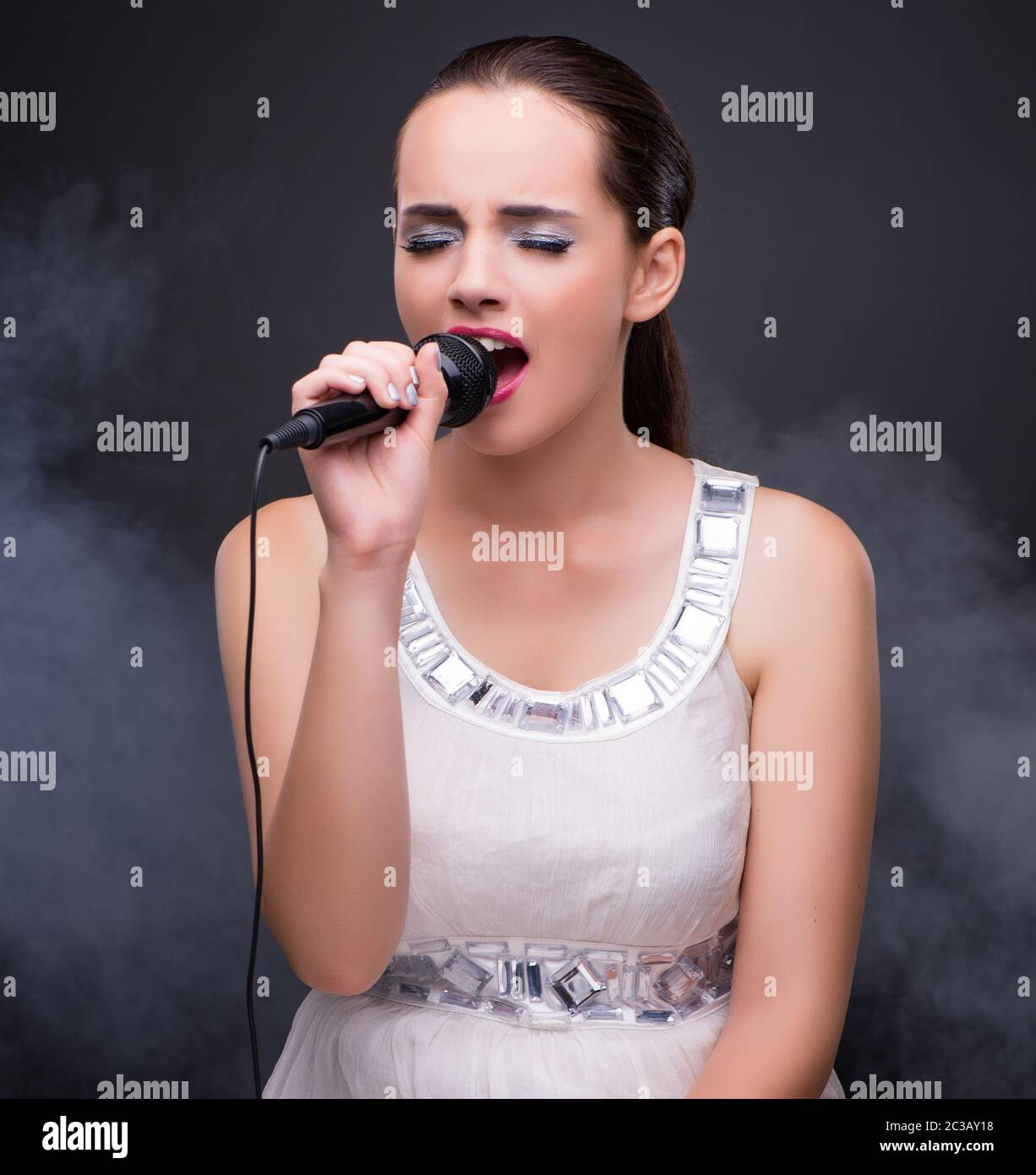 Young girl singing in karaoke club Stock Photo - Alamy