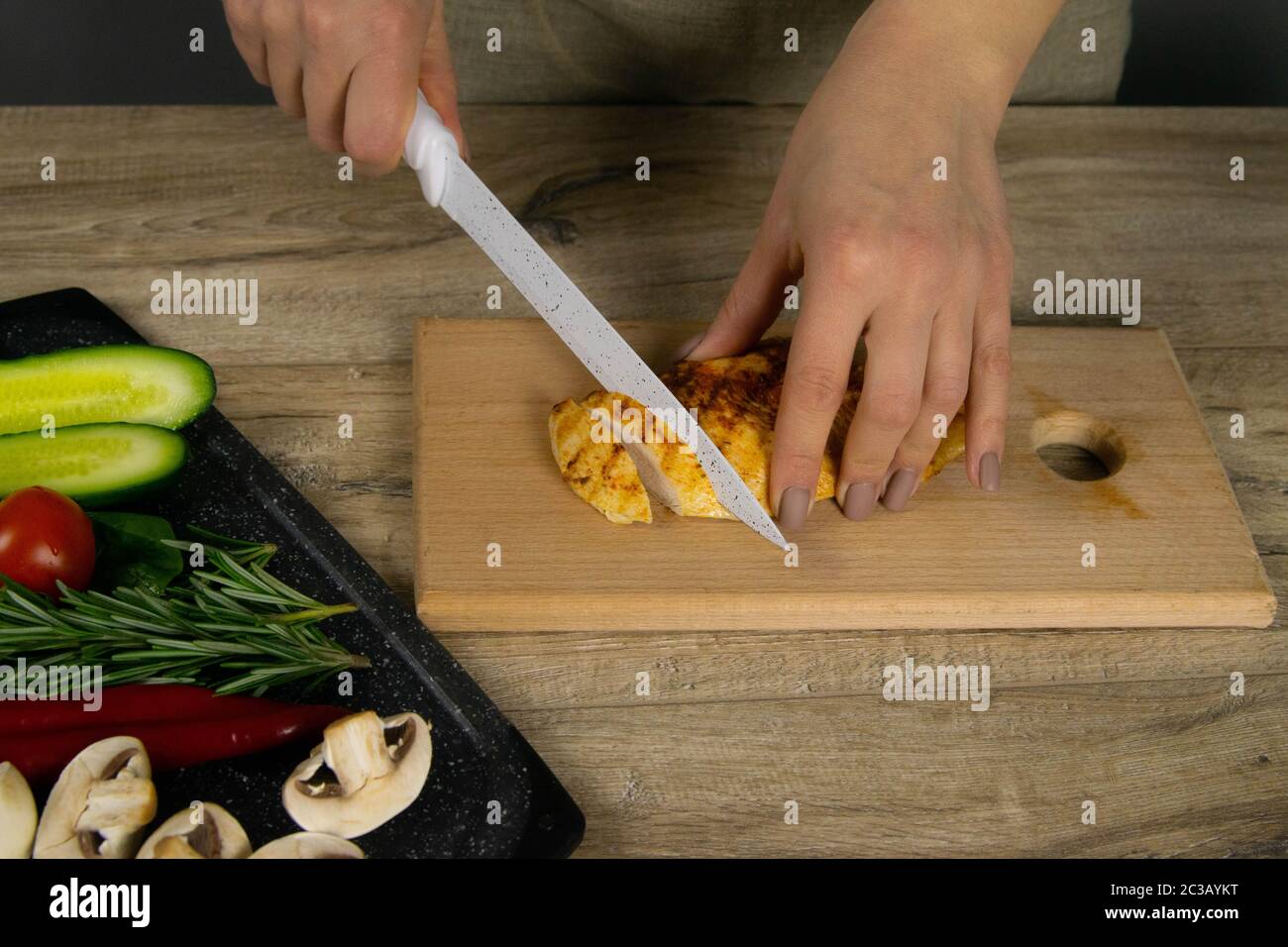 Chef cutting chicken fillet. Making Chicken and Egg Galette Series. Top ...