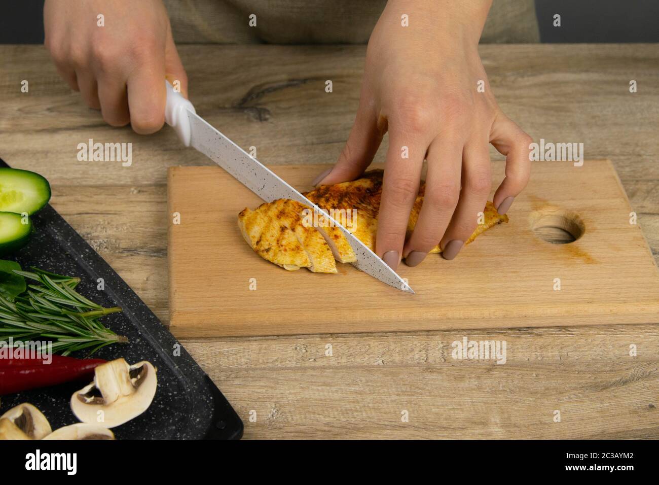 Chef cutting chicken fillet. Making Chicken and Egg Galette Series. Top ...