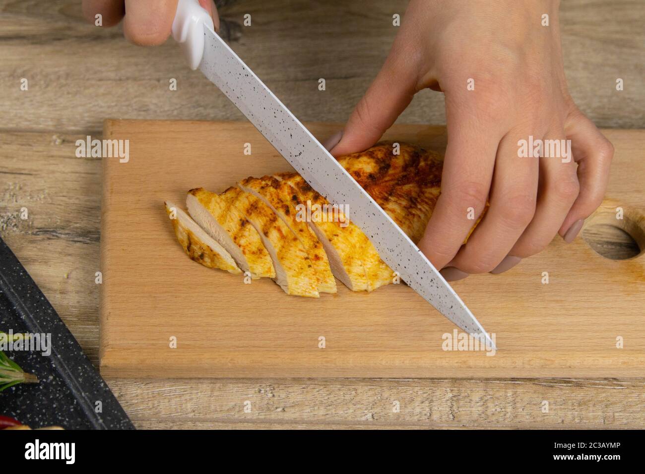Chef cutting chicken fillet. Making Chicken and Egg Galette Series. Top ...
