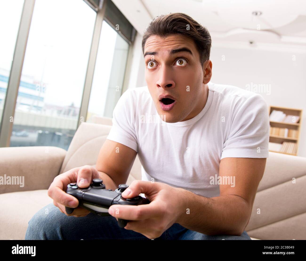Man addicted to computer games Stock Photo - Alamy
