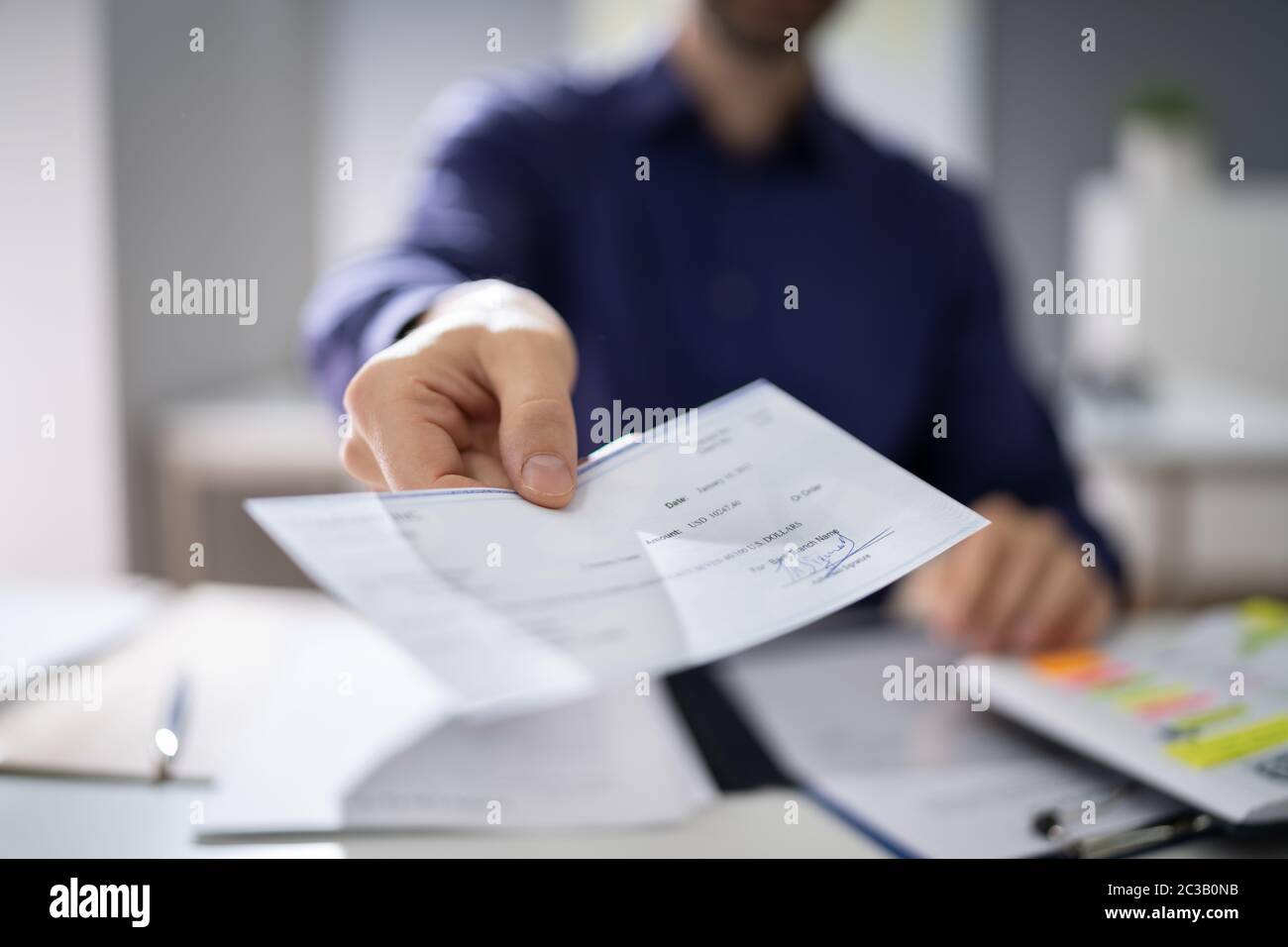 Businessperson Hands Giving Cheque To Other Person Stock Photo - Alamy