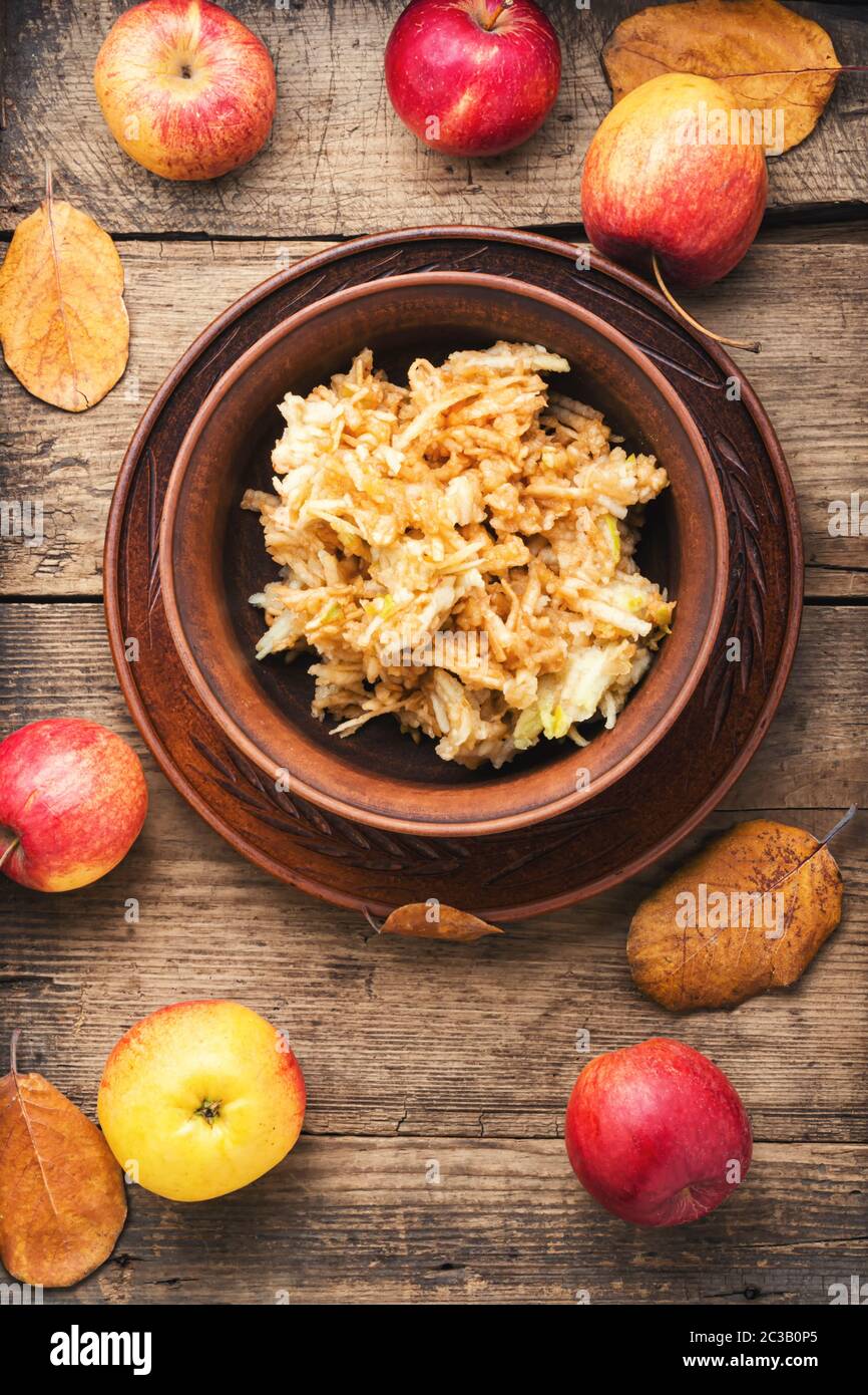 Grated ripe autumn apples in a plate on a wooden old table Stock Photo ...