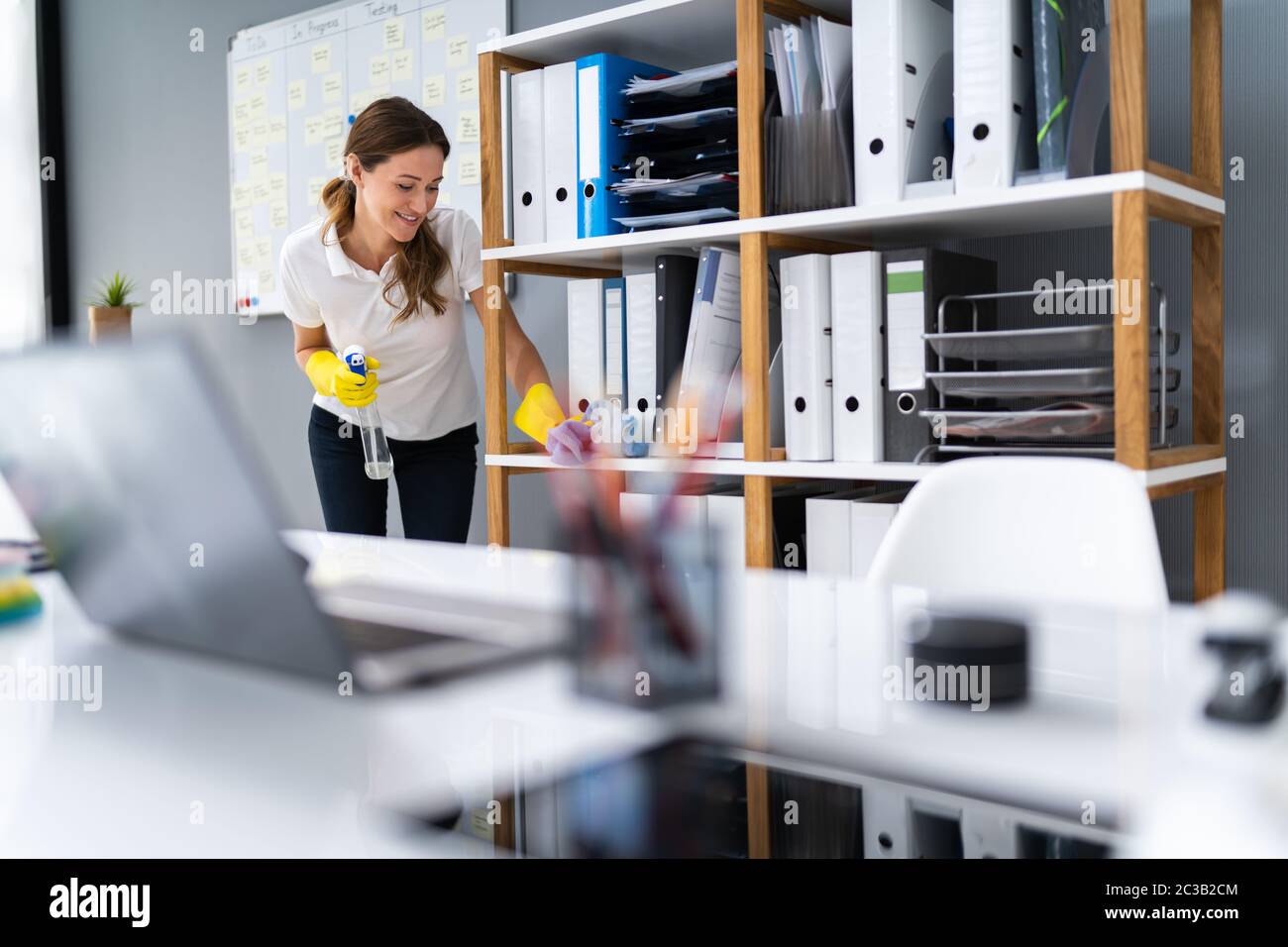 Female cleaner wiping office desk hi-res stock photography and images ...