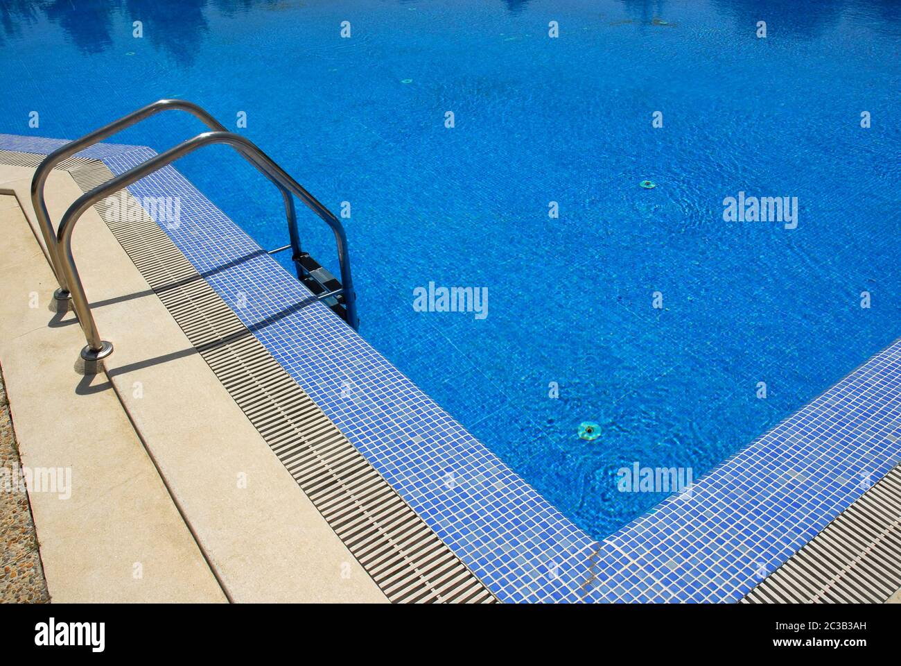 swimming pool blue water in a summer day Stock Photo - Alamy