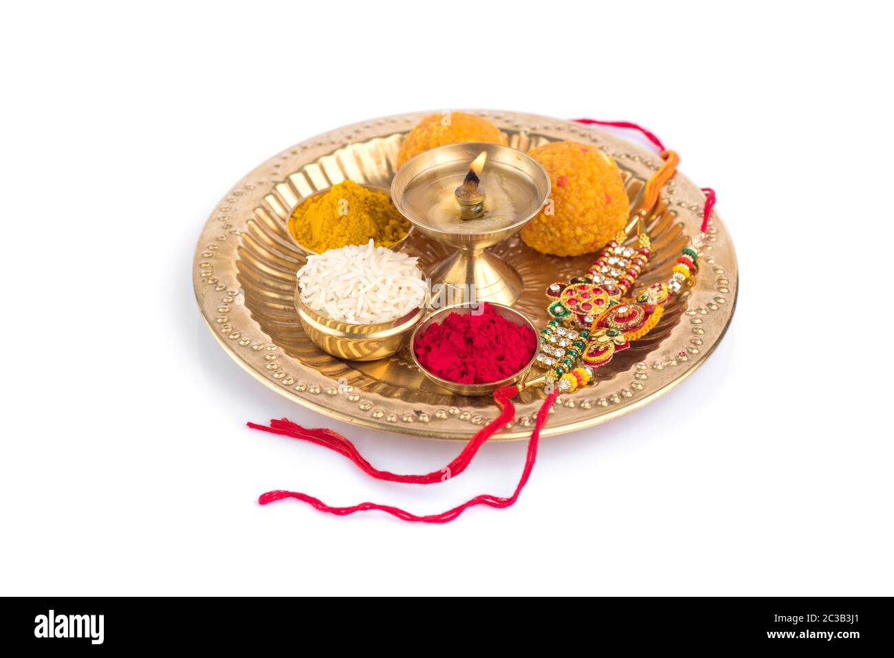 Indian Festival: Rakhi with rice grains, kumkum, sweets and diya on ...