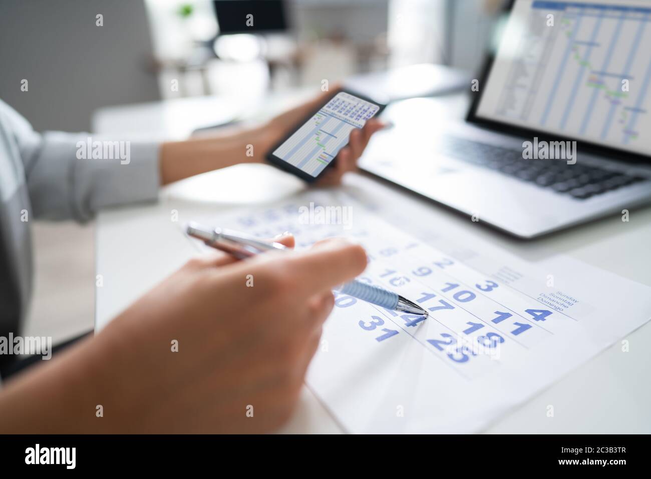 Woman looking at calendar on desk hi-res stock photography and images ...