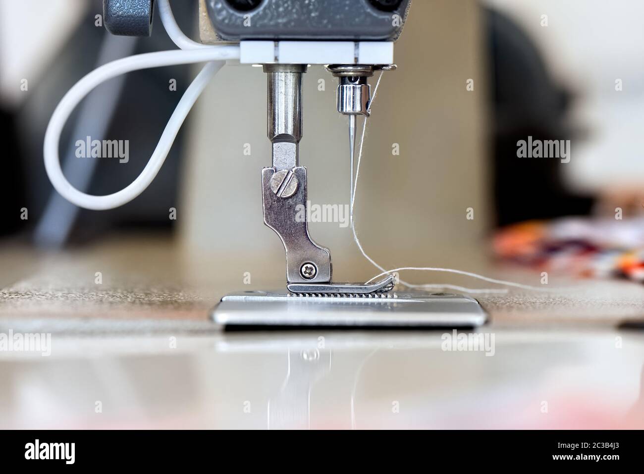 Sewing machine and white thread Stock Photo - Alamy