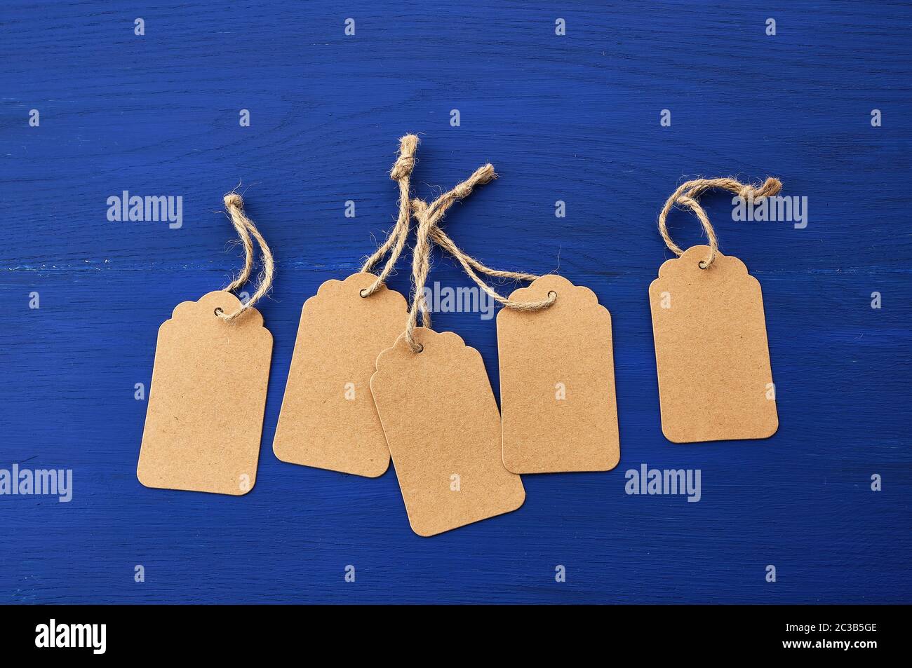 set of empty brown empty tags for clothes and other purposes on a blue ...
