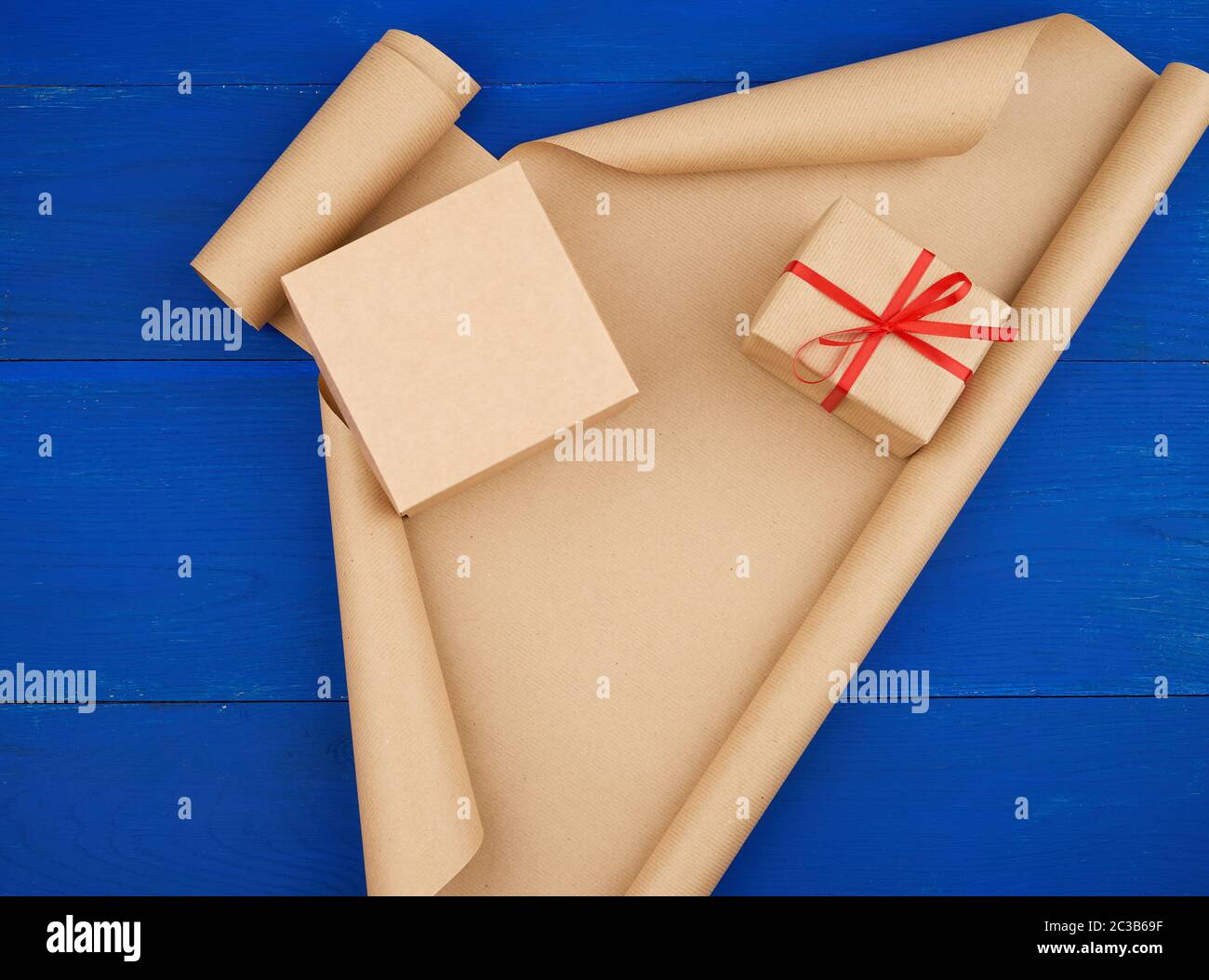 brown kraft paper, packed gift boxes and tied with a red ribbon, set of ...