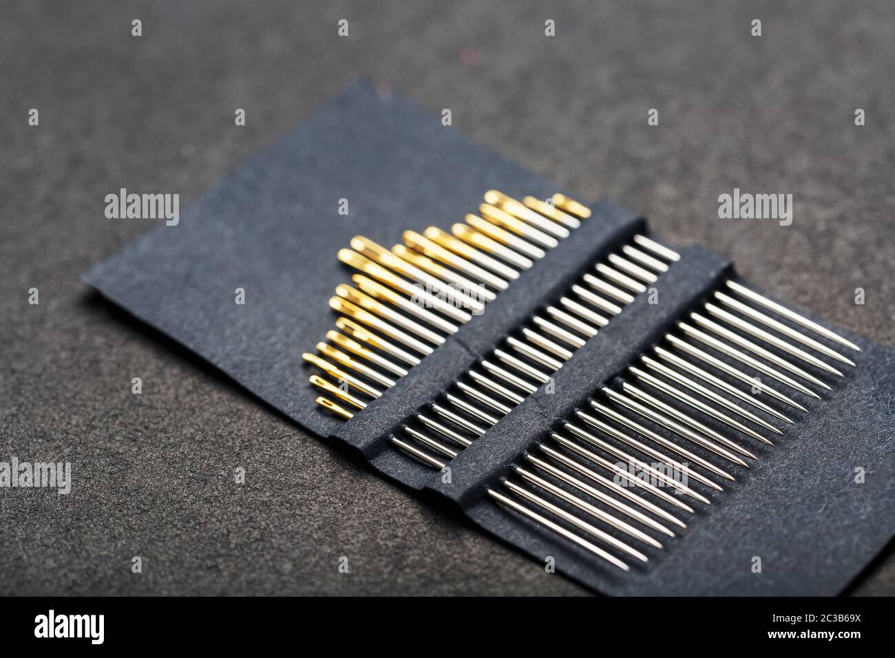 Set of Gold needles on a black background in a row Stock Photo - Alamy