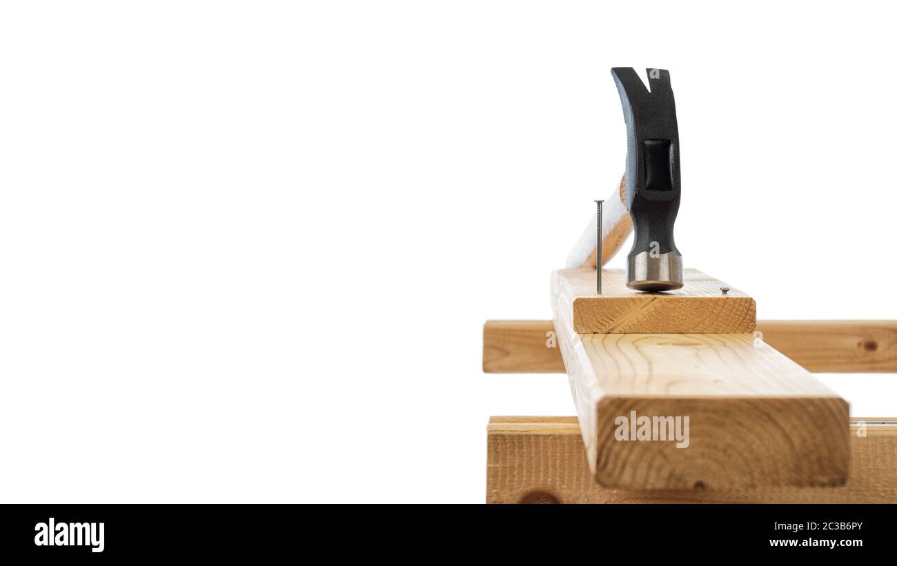 Close-up. Carpenter’s hammer over a wooden board. Construction industry ...