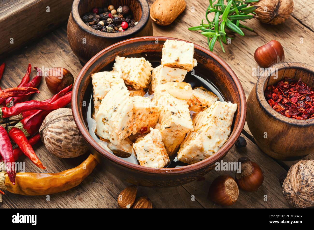 Feta cheese with herbs and garlic on old wooden background Stock Photo ...