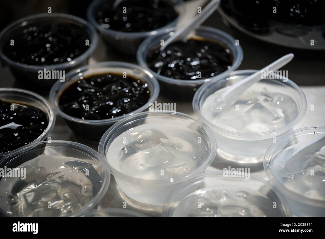 Plastic transparent bowls with sweet jelly chinese dessert on a self ...
