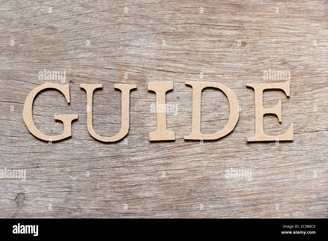 Alphabet letter in word guide on wood background Stock Photo - Alamy