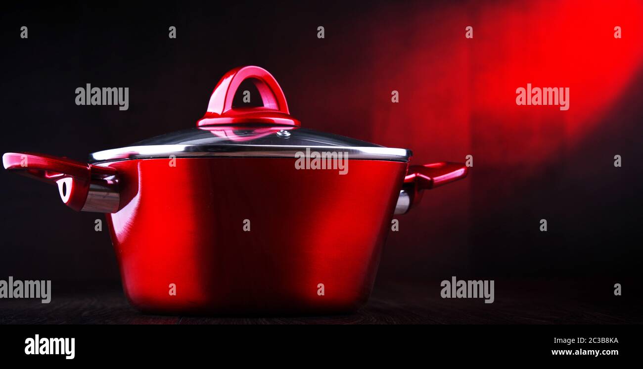 Composition with red steel pot Stock Photo - Alamy