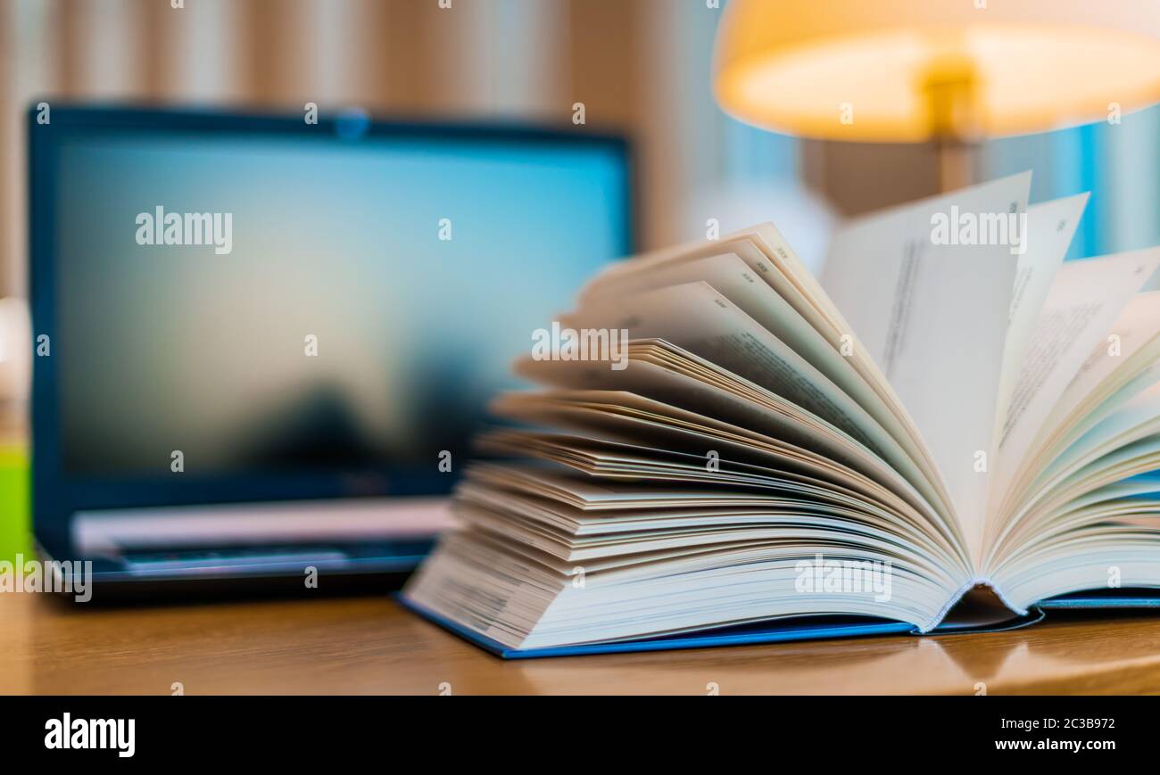 Open book lying on the table in the public library Stock Photo - Alamy