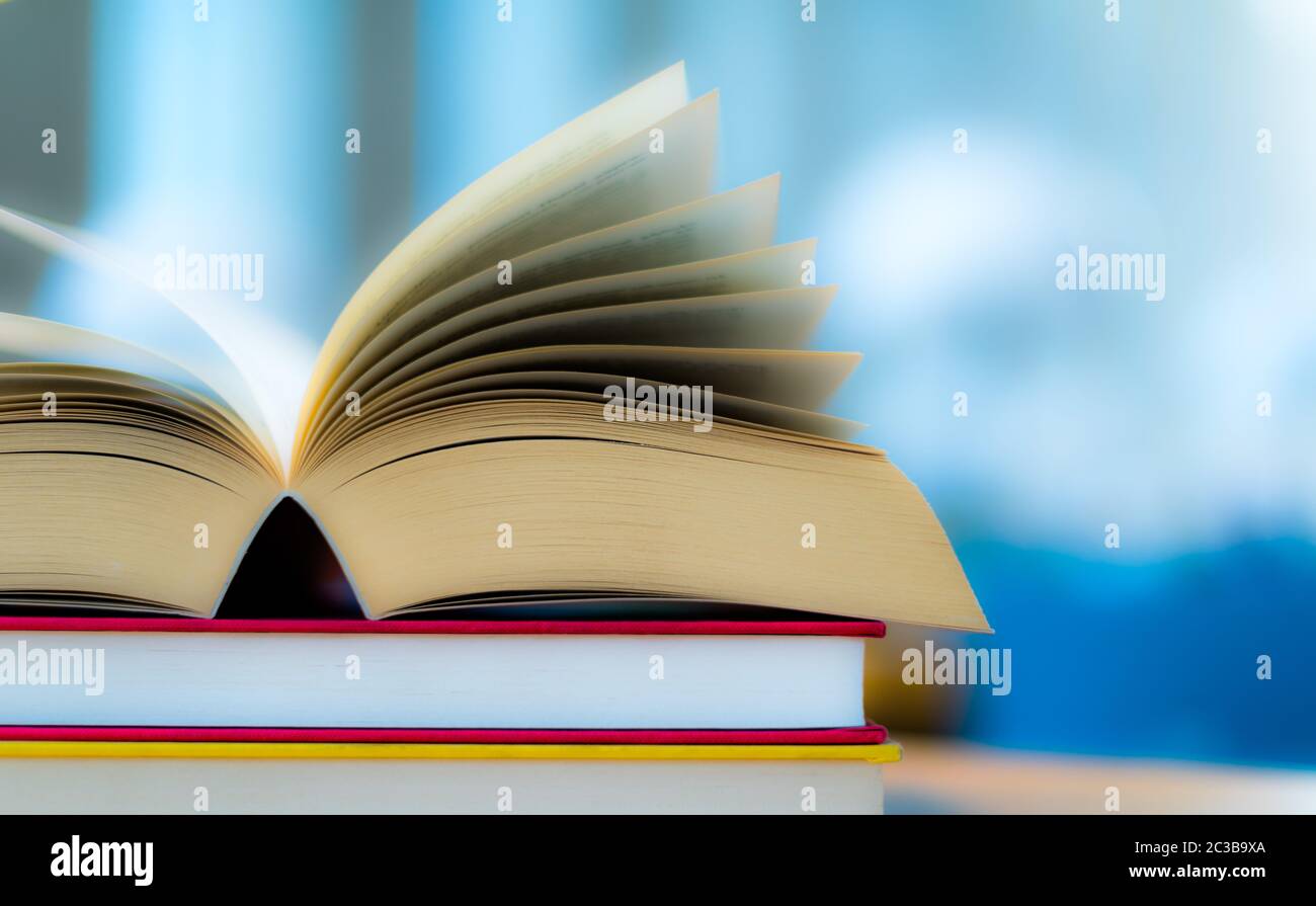 Open book lying on the table in the public library Stock Photo - Alamy