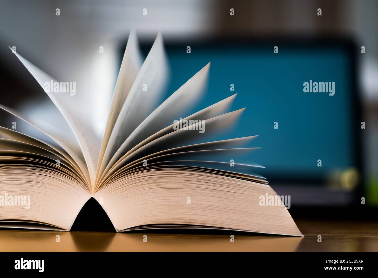 Open book lying on the table in the public library Stock Photo - Alamy