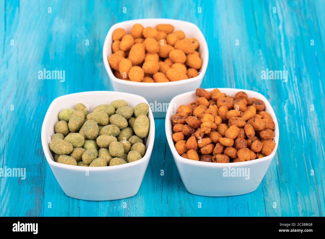 Mix of nuts in wasabi and spice batter on wood background Stock Photo ...