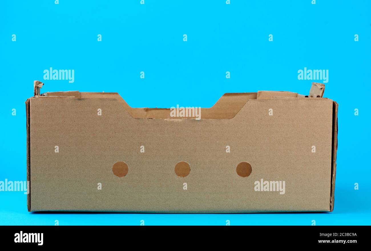 rectangular empty cardboard box of brown paper on a blue background ...