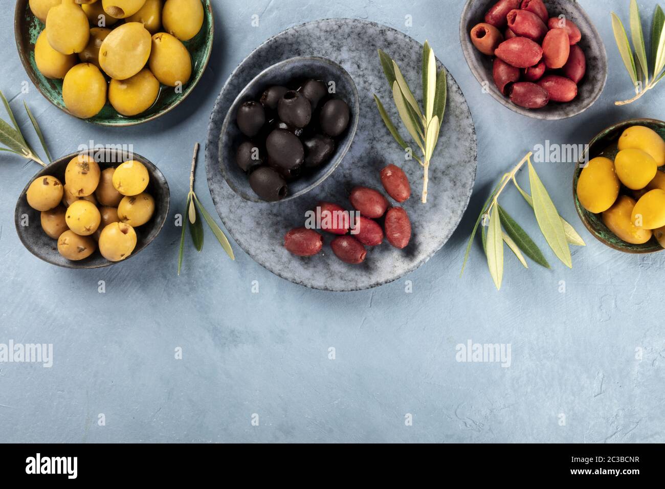 Olives flat lay top shot with copy space. Black, green and red olives ...