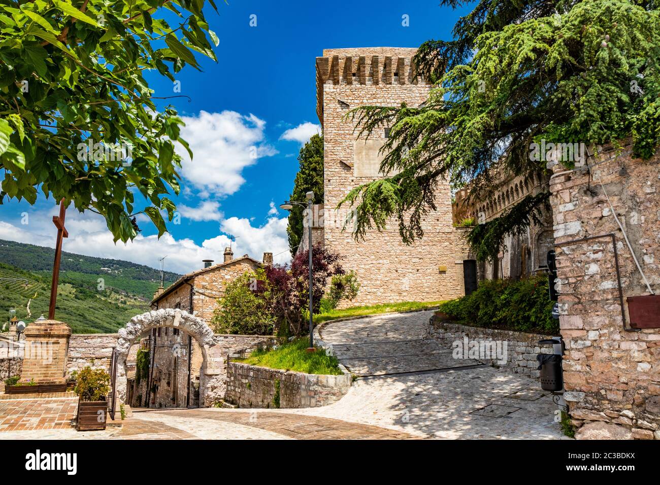 The tower and the medieval walls, in stone and brick, with merlon. A ...