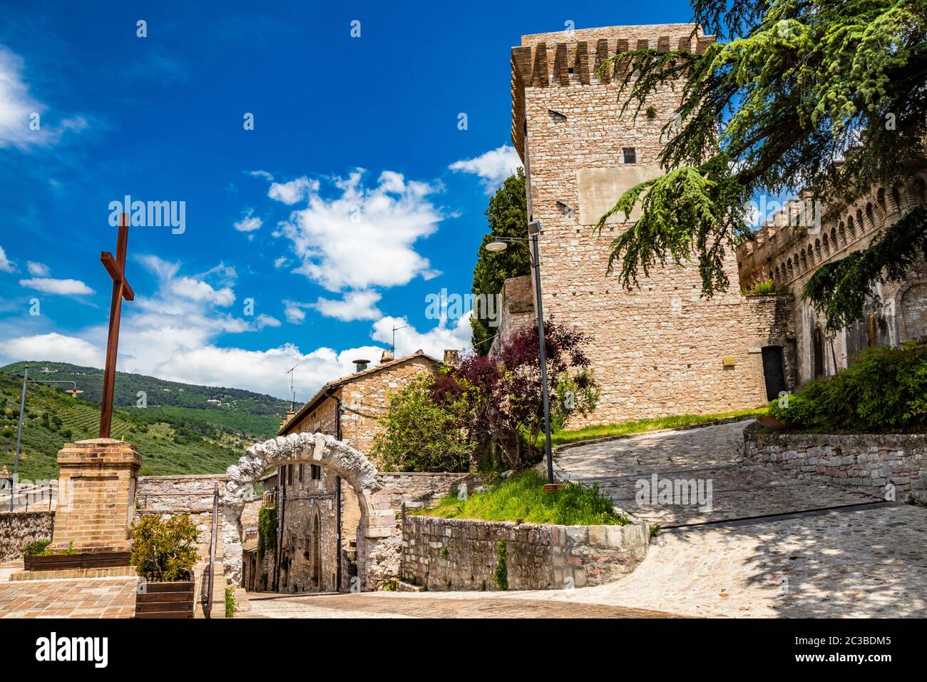 The tower and the medieval walls, in stone and brick, with merlon. A ...