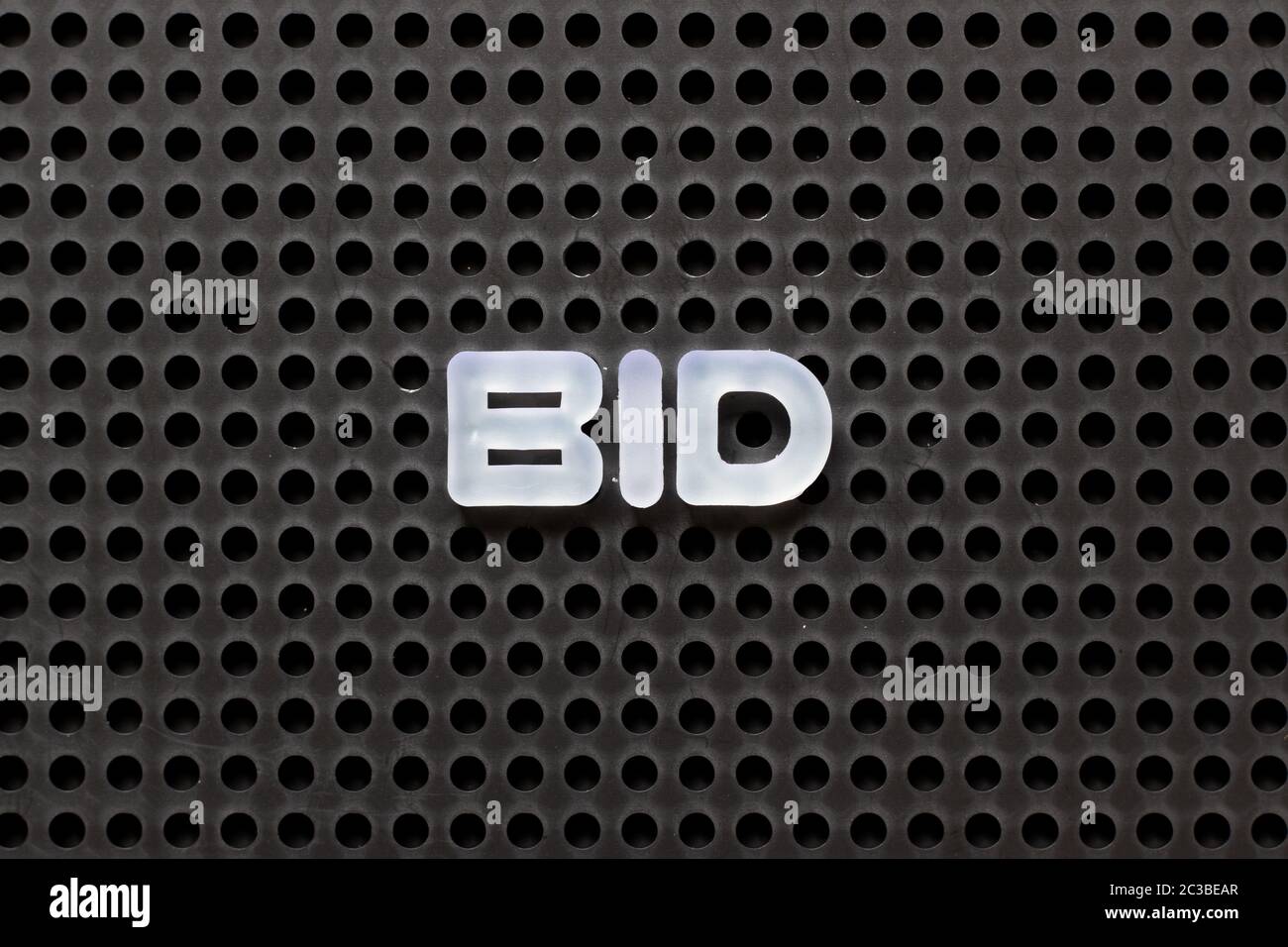 Black color pegboard with white letter in word bid Stock Photo - Alamy