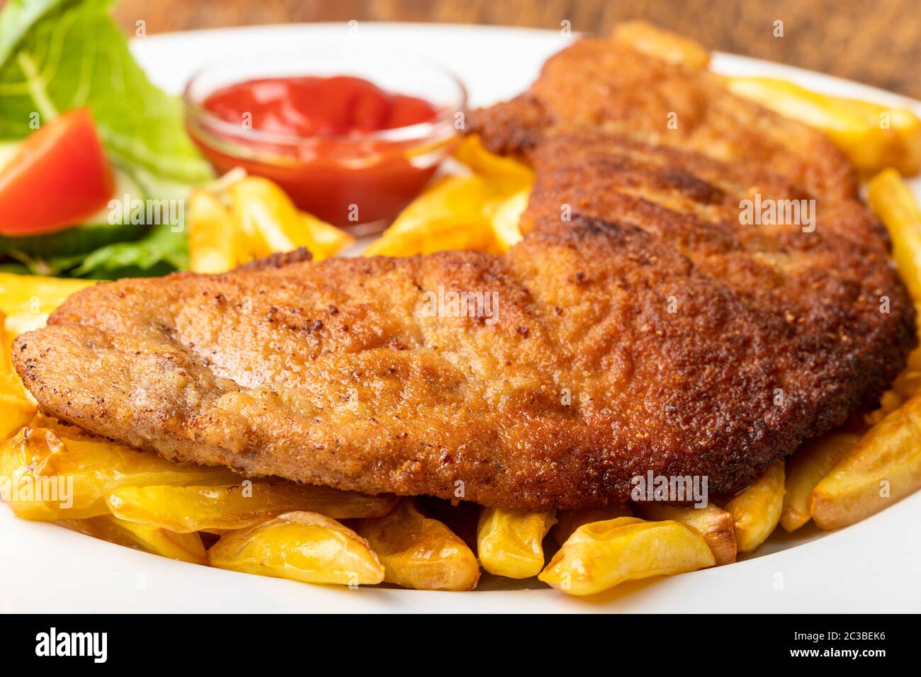 Wiener schnitzel with french fries on a plate hi-res stock photography ...