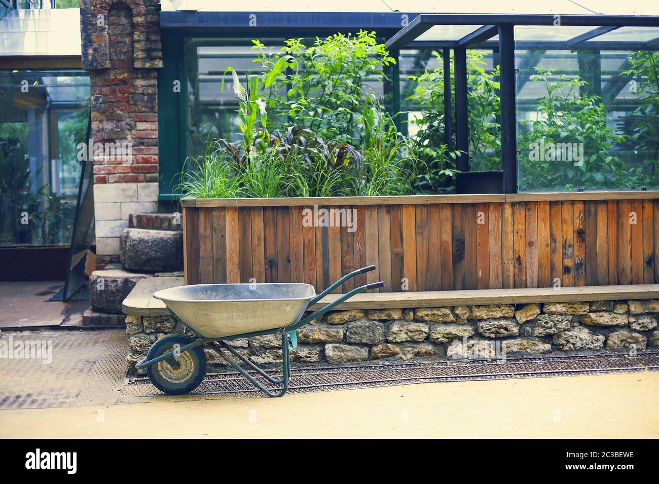 Garden wheelbarrow in modern backyard Stock Photo - Alamy