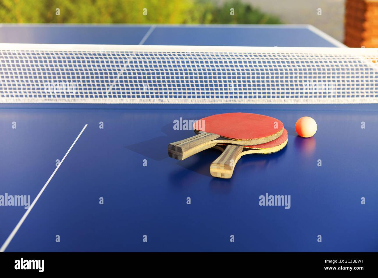 Ping pong equipment on blue table Stock Photo - Alamy