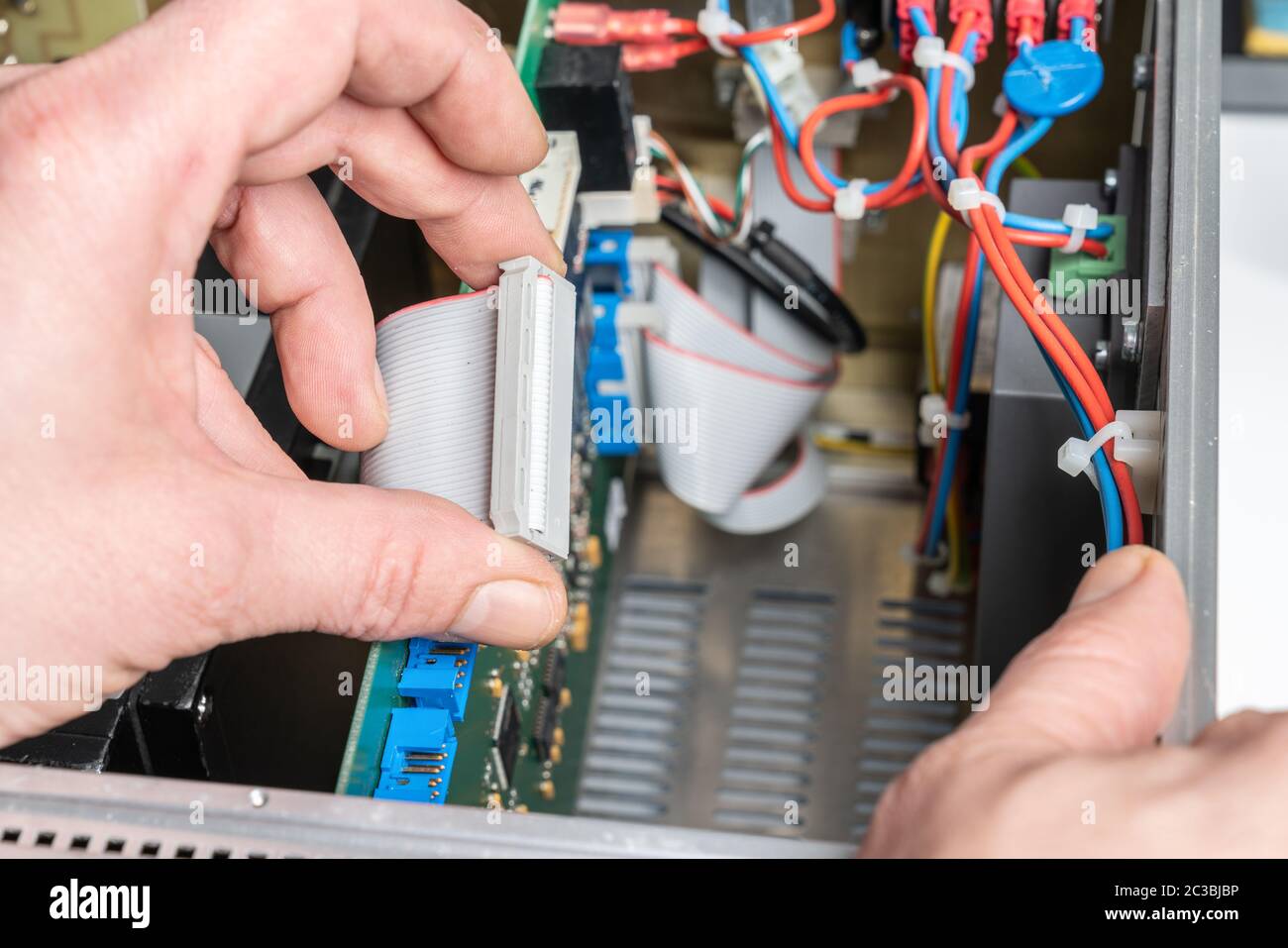 a technician assembles components of an electrical device Stock Photo ...