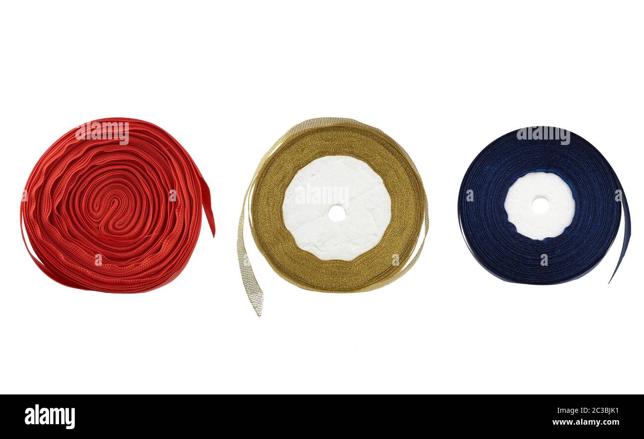 round bobbins with red, blue, golden ribbon on a white background ...