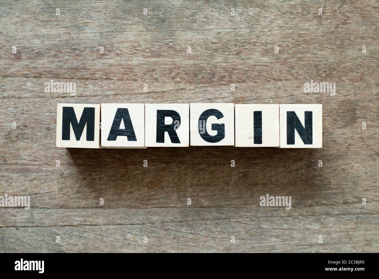Letter block in word margin on wood background Stock Photo - Alamy