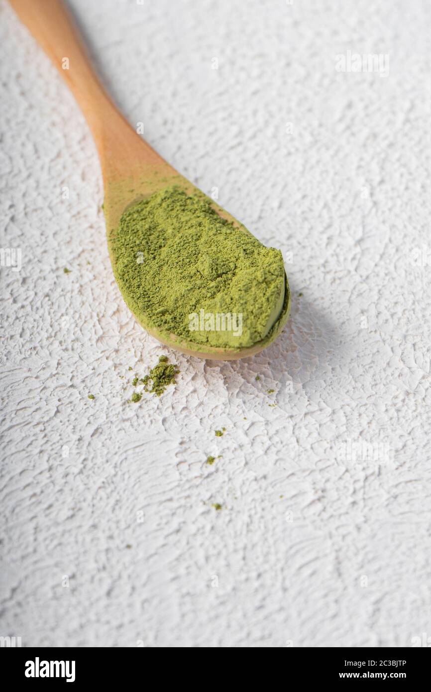 green powder of Chinese matcha tea on a white light background ...